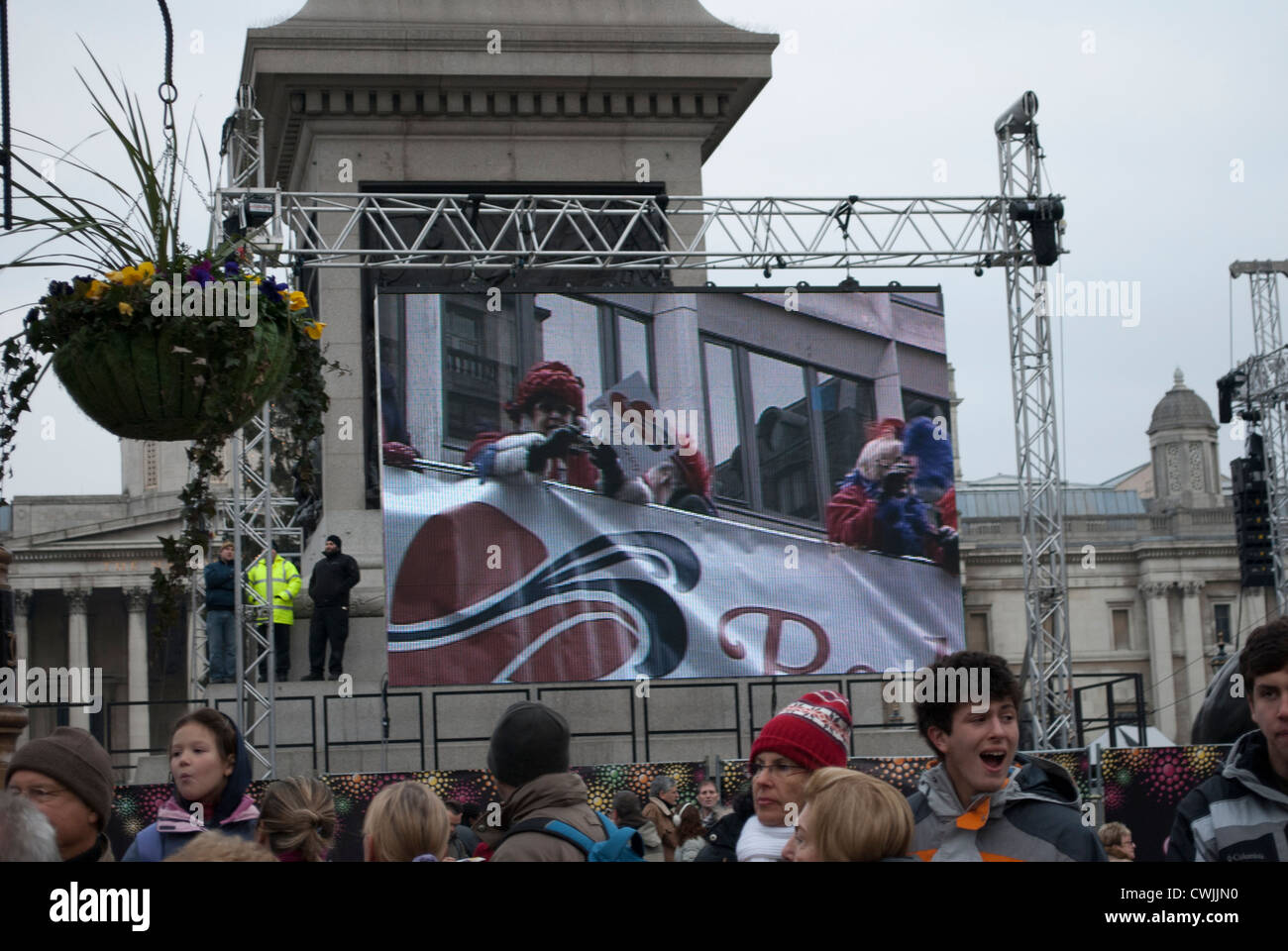 Red Hat Society members on an open topped bus on display screen in ...