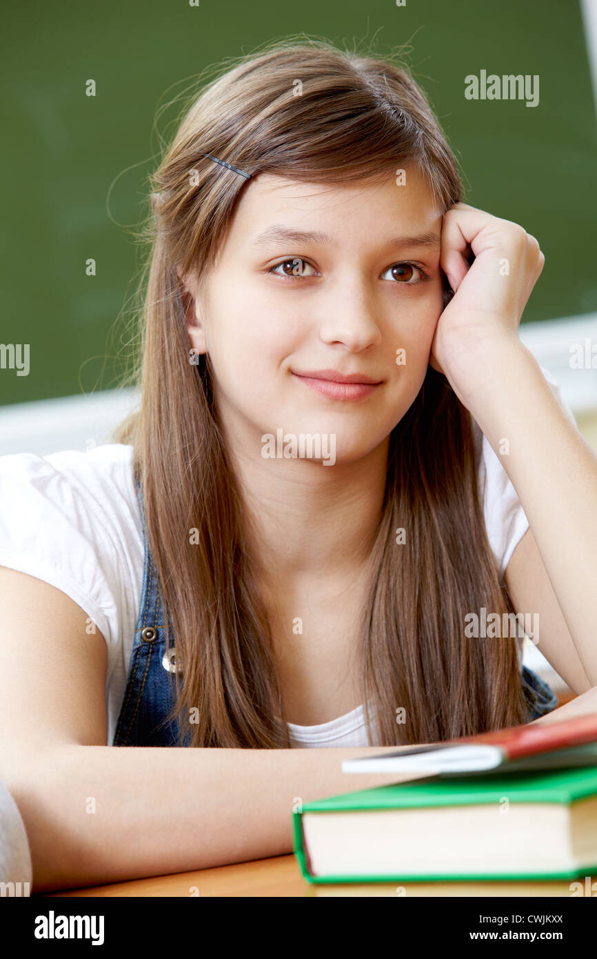 Portrait of pretty girl at workplace interested in subject Stock Photo ...