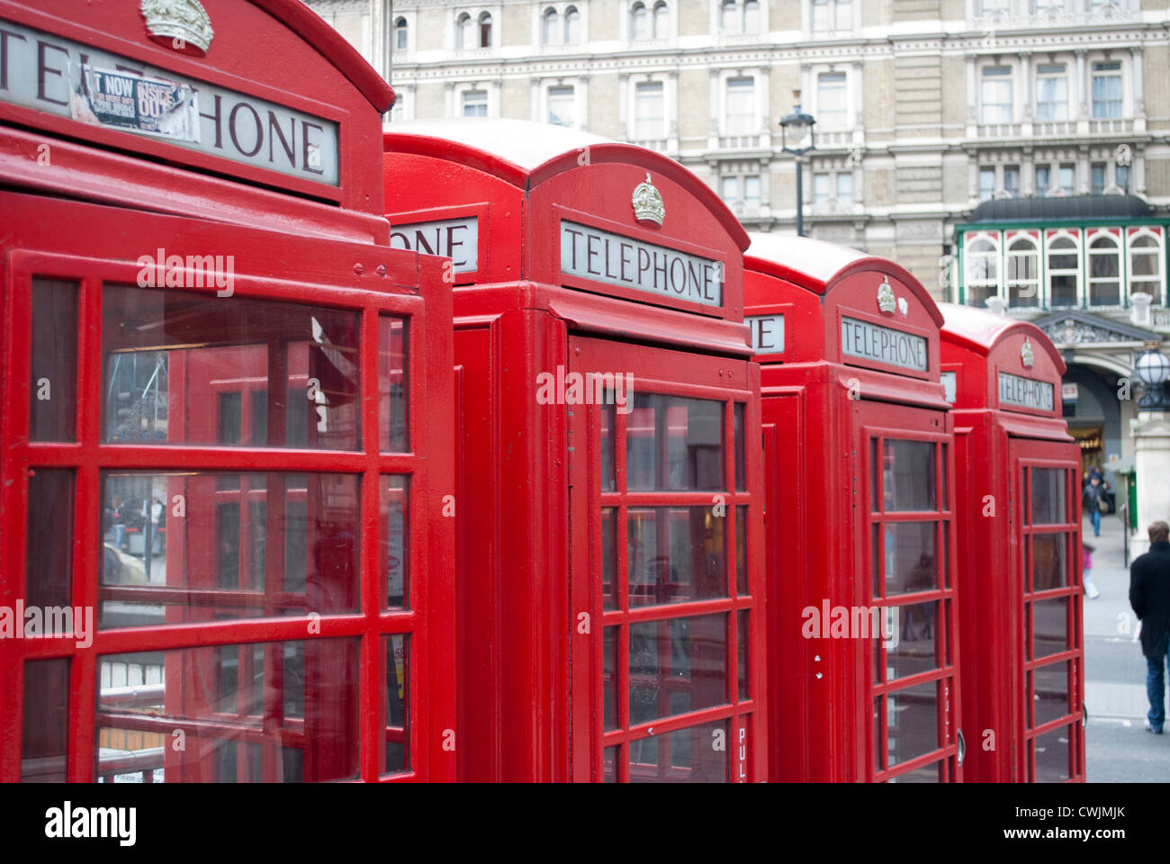 Four red telephone boxes in a row Stock Photo - Alamy