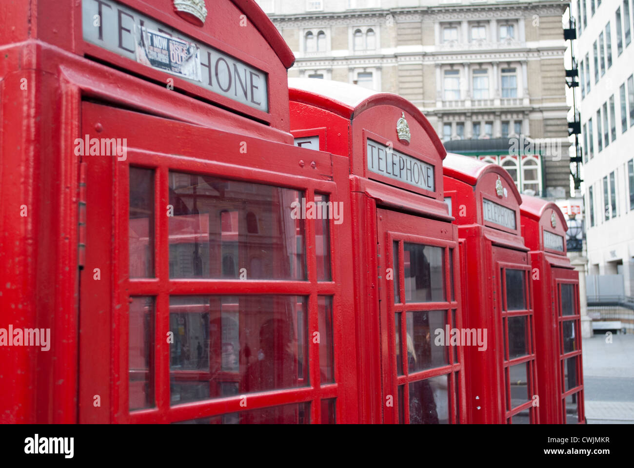 Four red telephone boxes in a row Stock Photo - Alamy