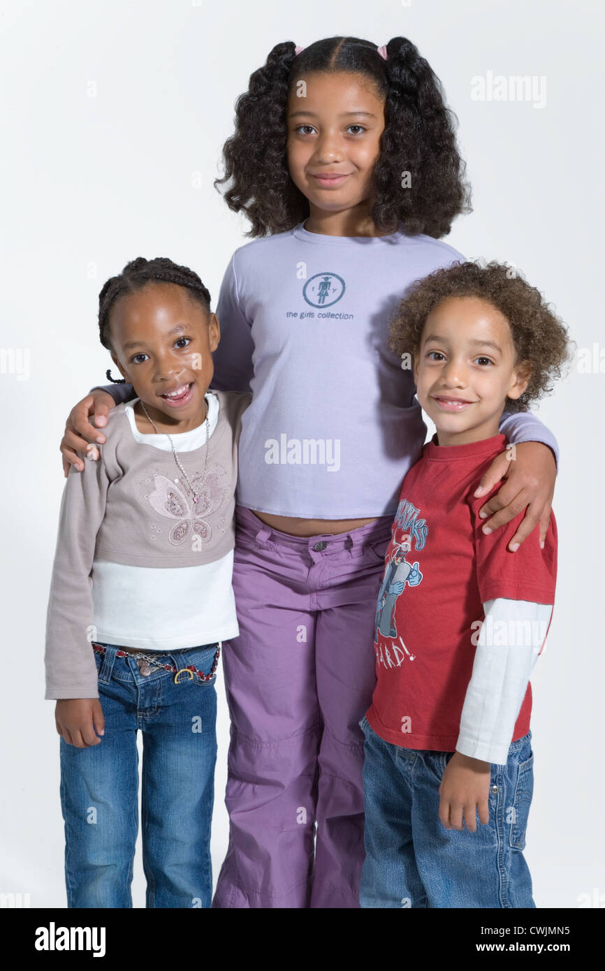 Three children smiling Stock Photo - Alamy