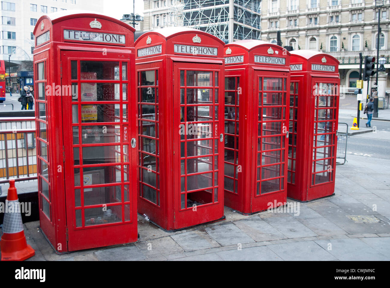 Four red telephone boxes in a row Stock Photo - Alamy