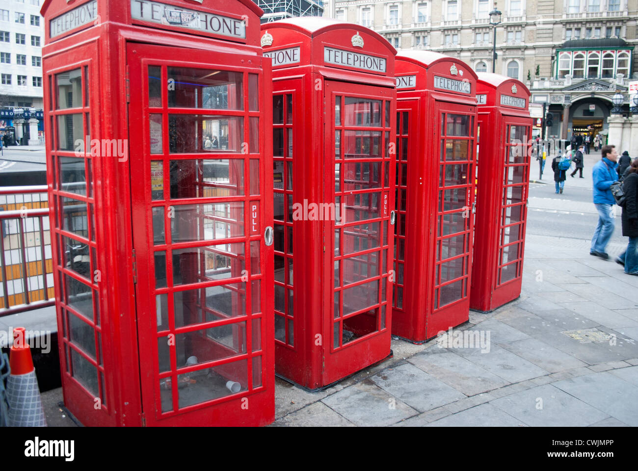 Four red telephone boxes in a row Stock Photo - Alamy