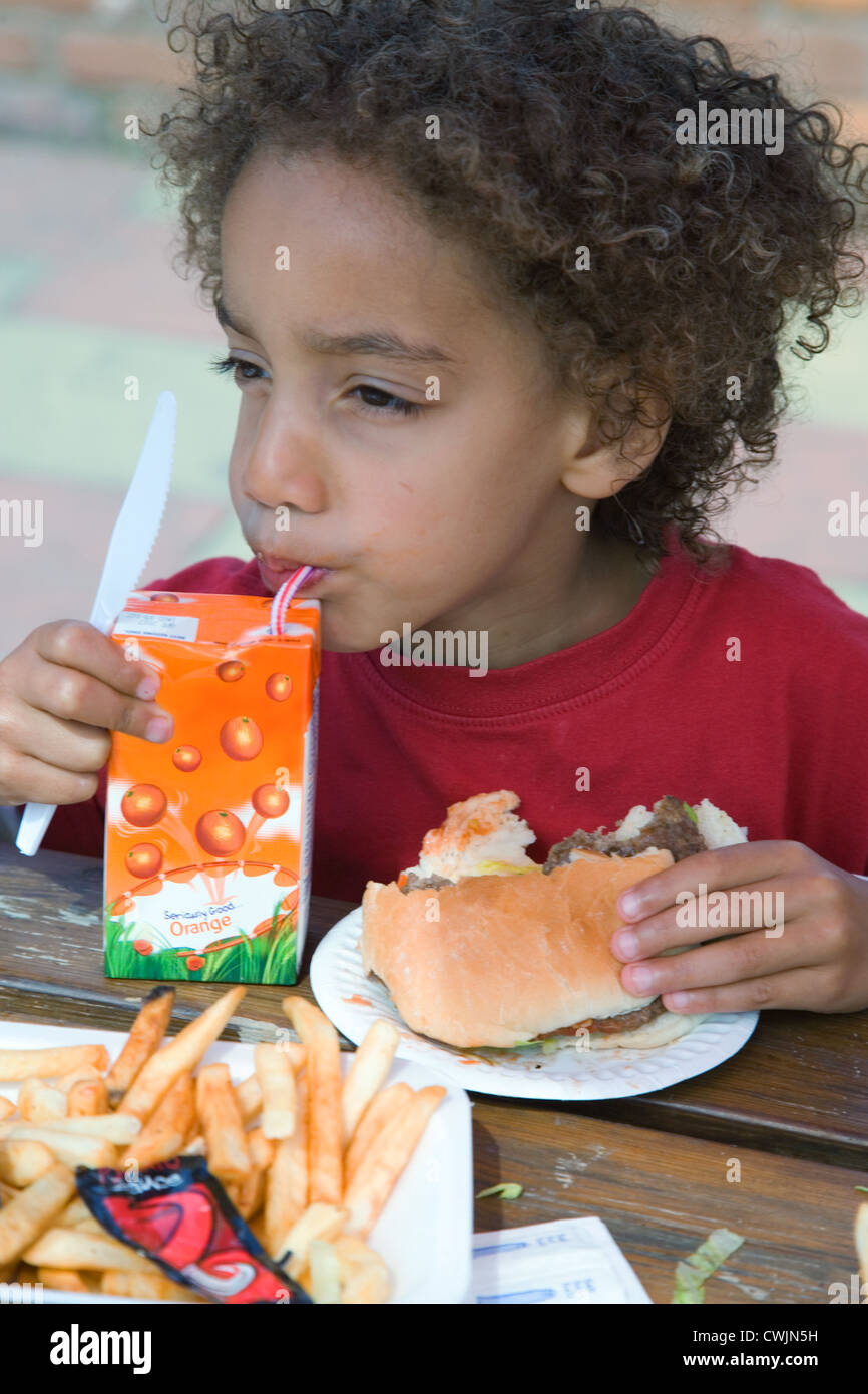 Little boy on a day out enjoying a snack Stock Photo - Alamy