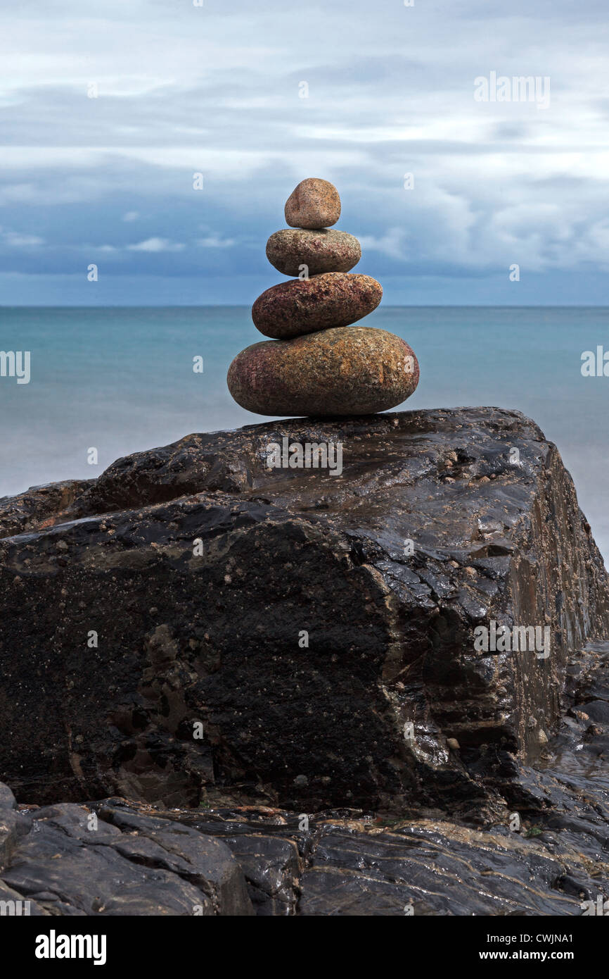 A pebble sculpture on a large rock Stock Photo - Alamy