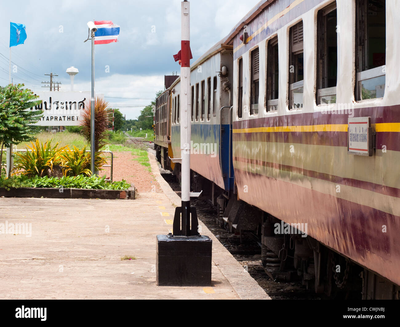 Passenger train with 3rd class cars waiting at the station in ...