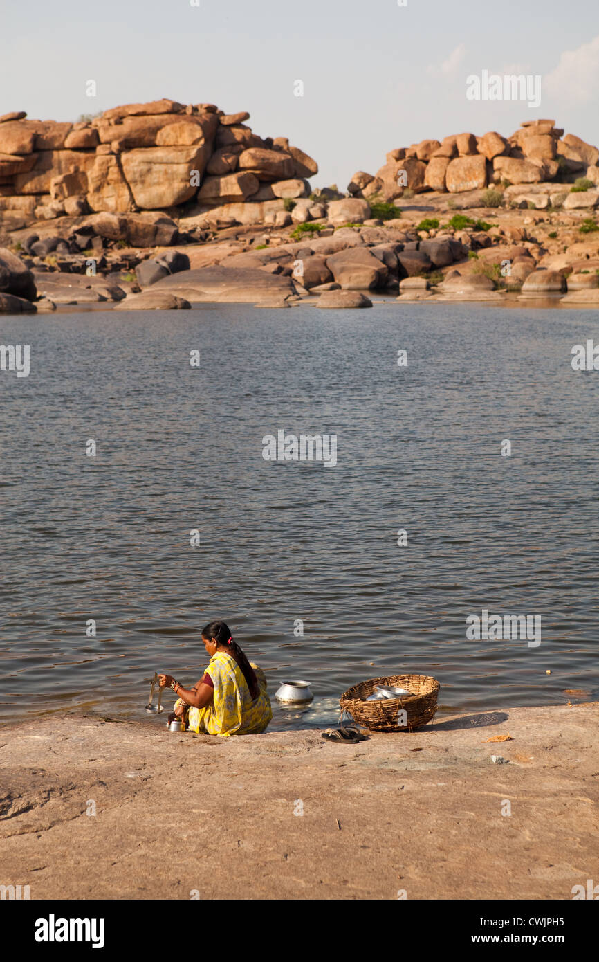 Indian woman washing clothes in the Tungabhadra river in Hampi Stock ...