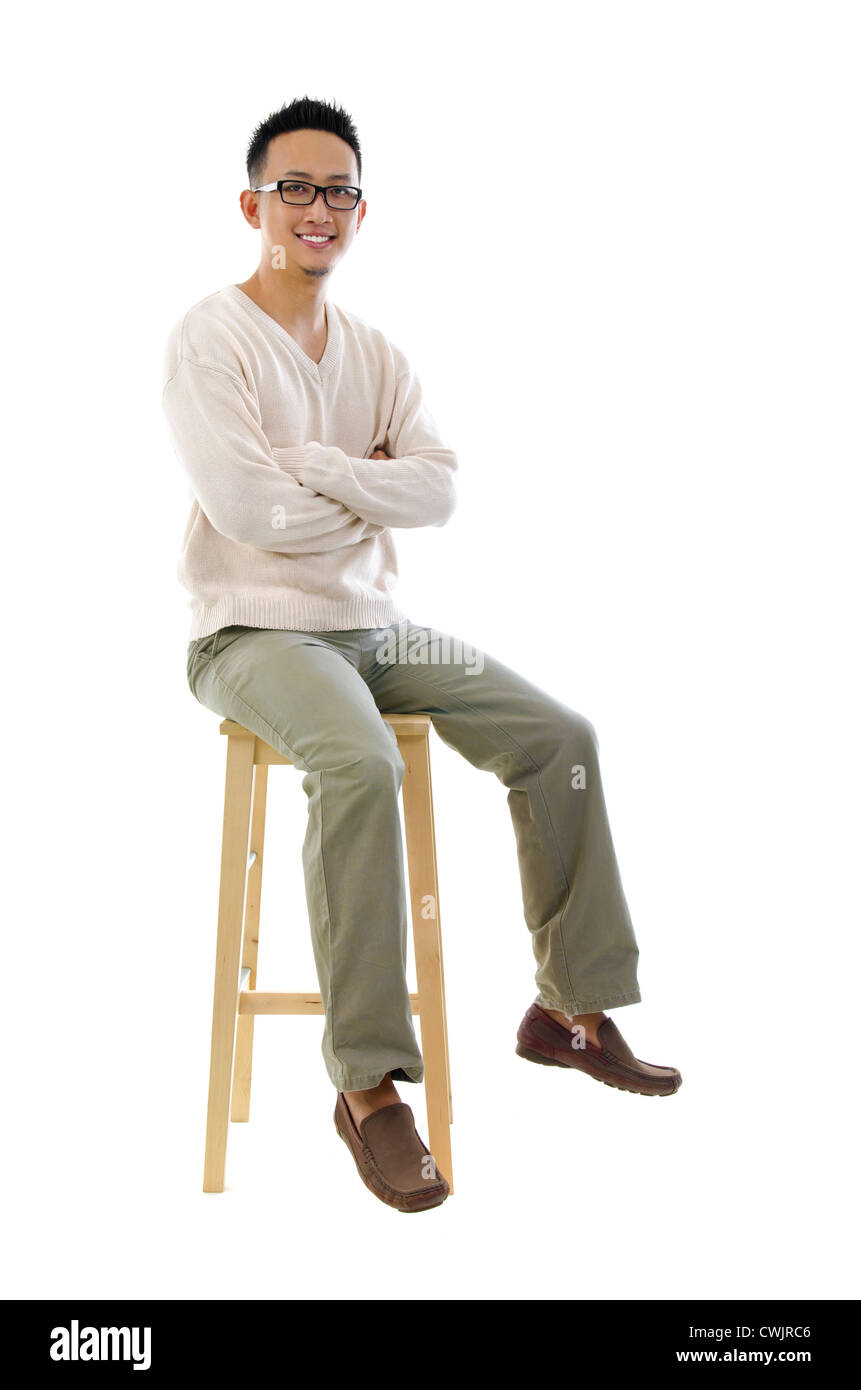 Full body Asian man sitting on a chair over white background Stock ...