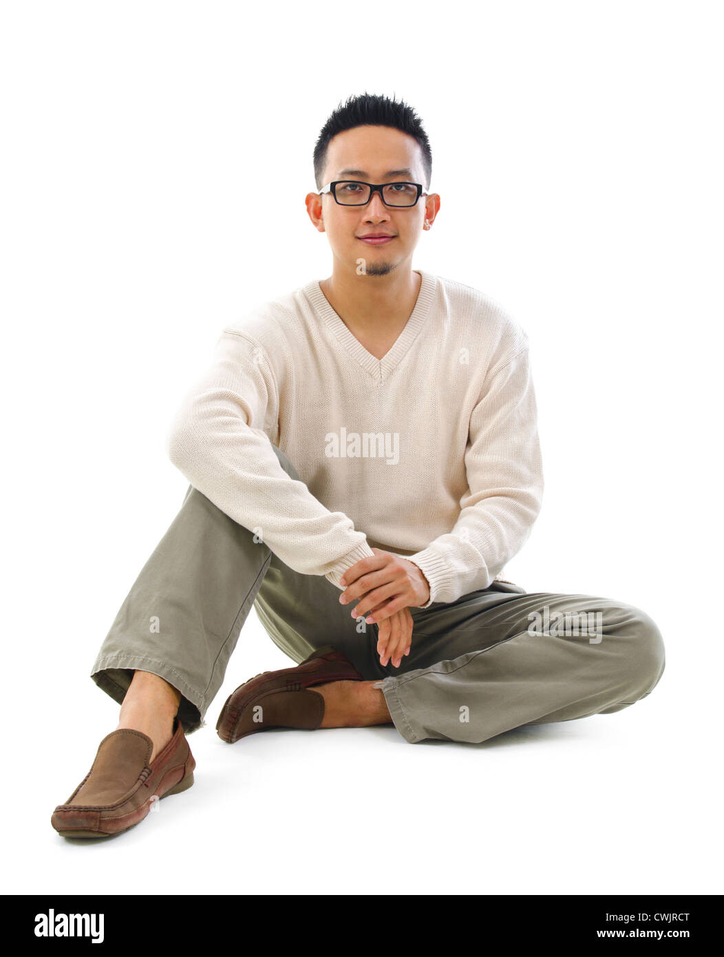 Full body Asian man sitting on white floor Stock Photo - Alamy
