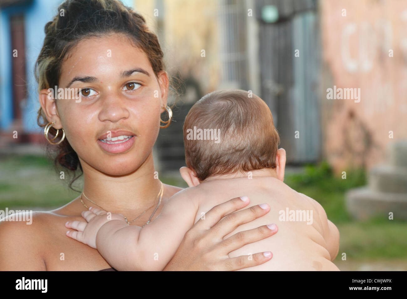 Hispanic Cuban young mother and her baby close up. People on the ...