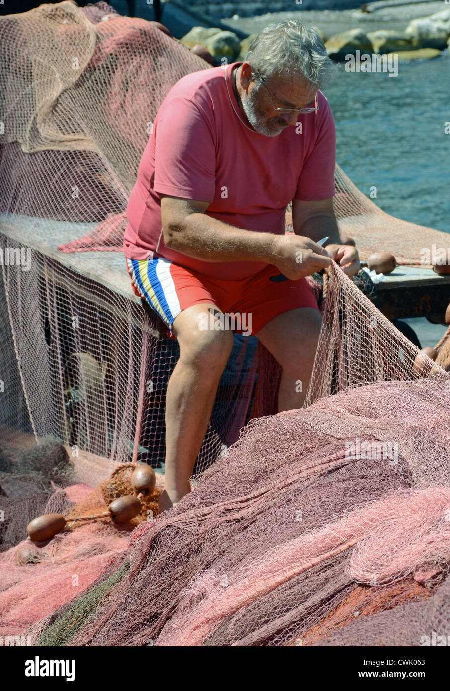 Fishermen mending nets hi-res stock photography and images - Alamy