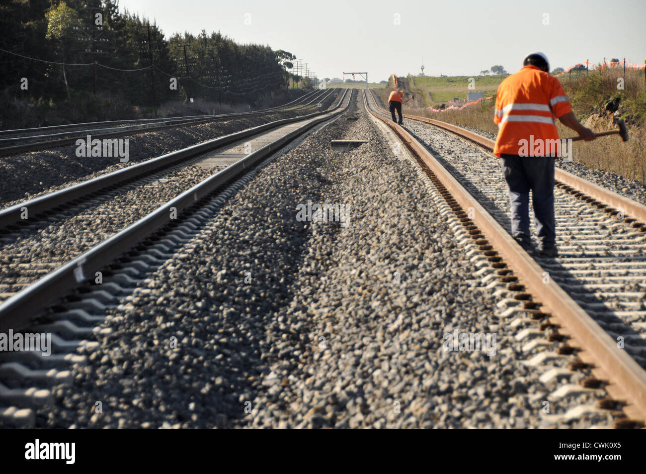 Railway Worker undertaking track maintenance Stock Photo - Alamy