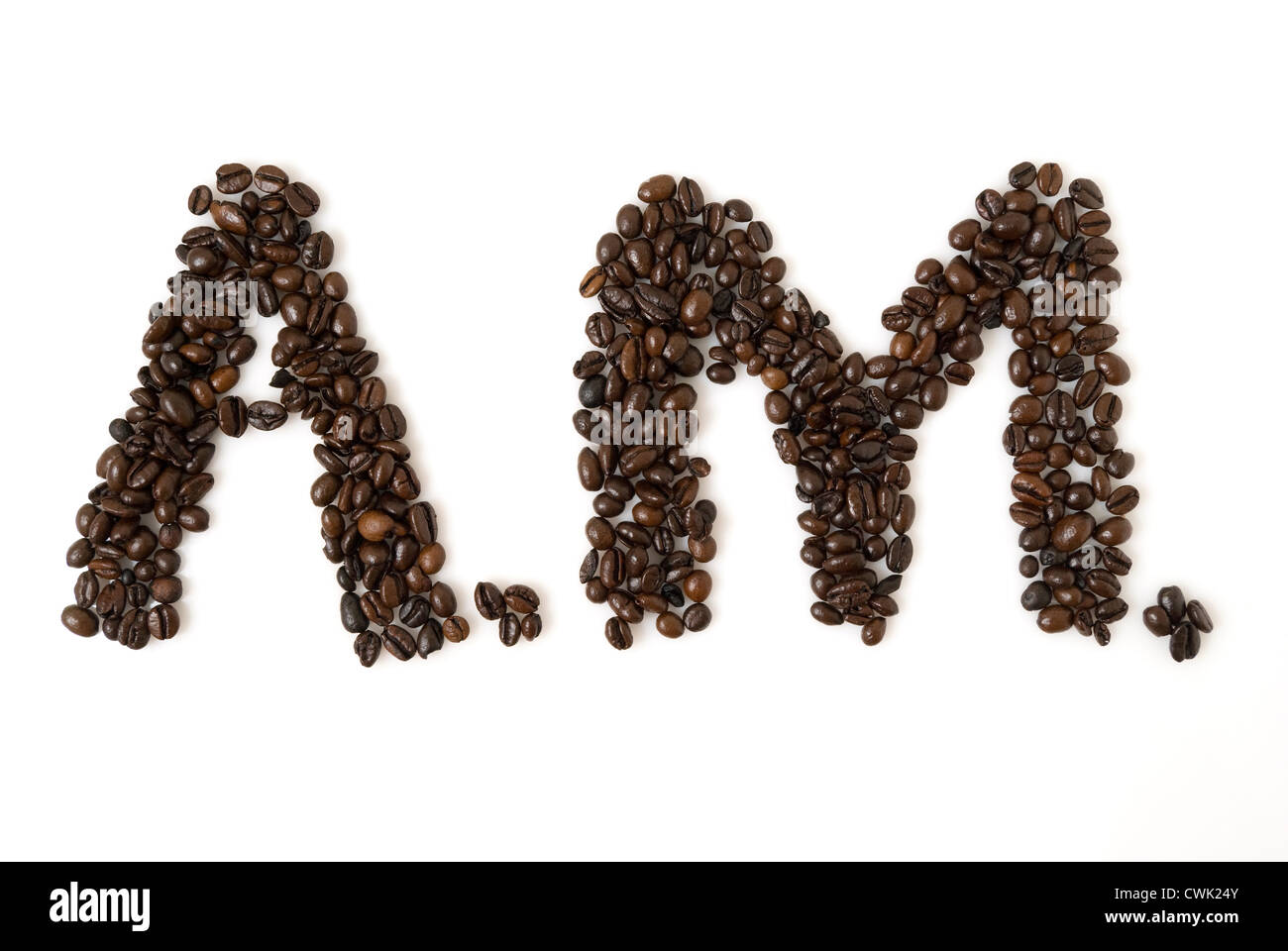 A.M. for morning written with coffee beans; shot against white ...