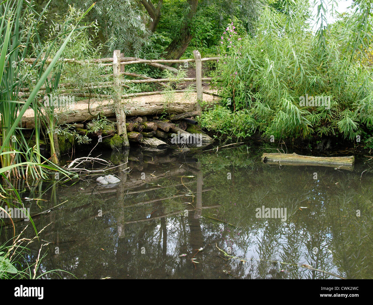 Rustic wooden bridge over a stream, UK Stock Photo - Alamy