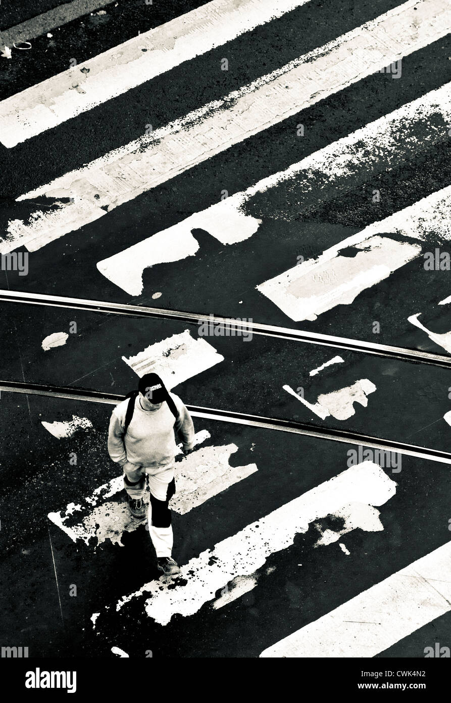 Man crossing a street on a pedestrian crossing Stock Photo - Alamy