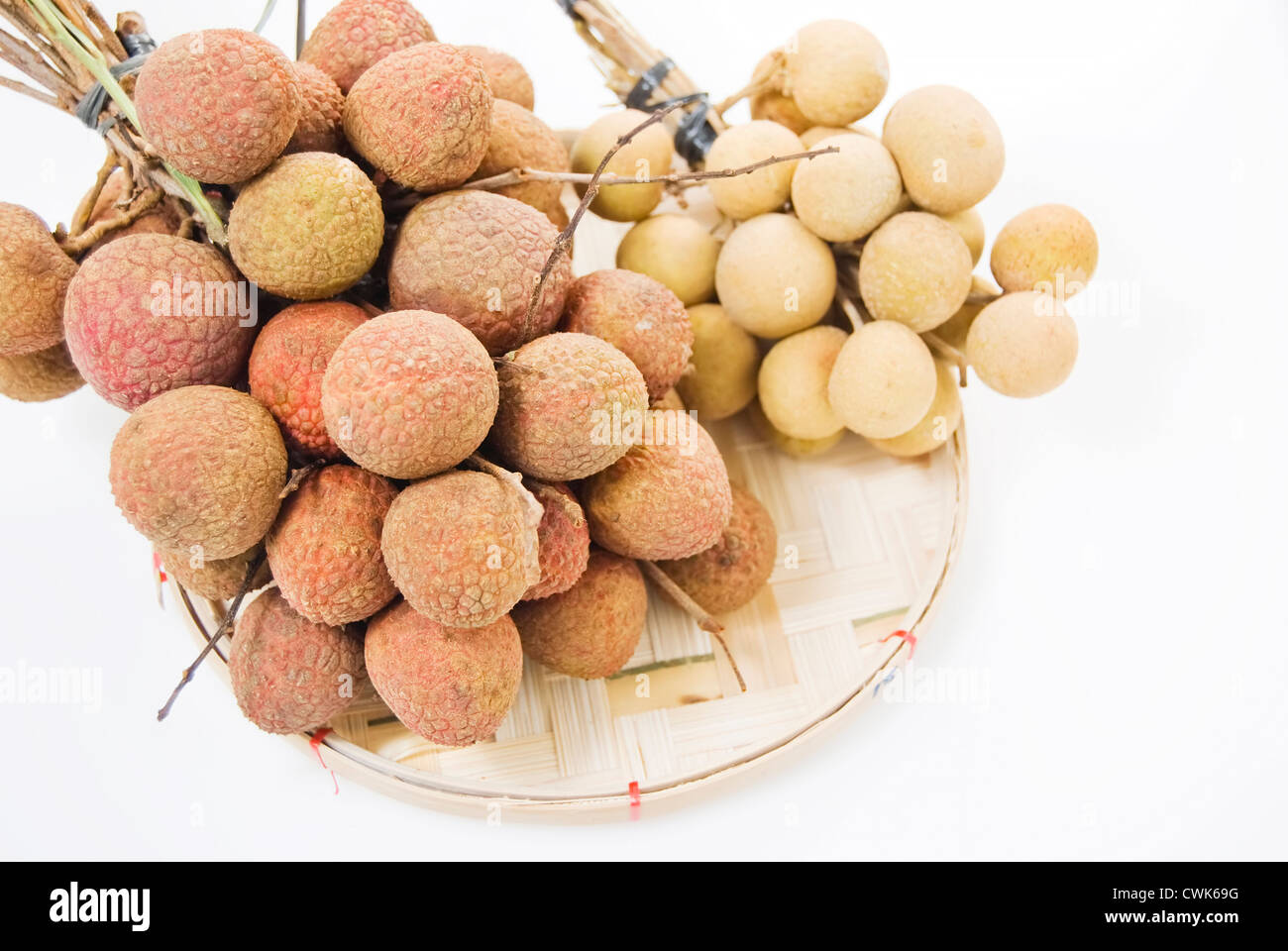 Lychee and longan fruits on woven bamboo tray Stock Photo - Alamy