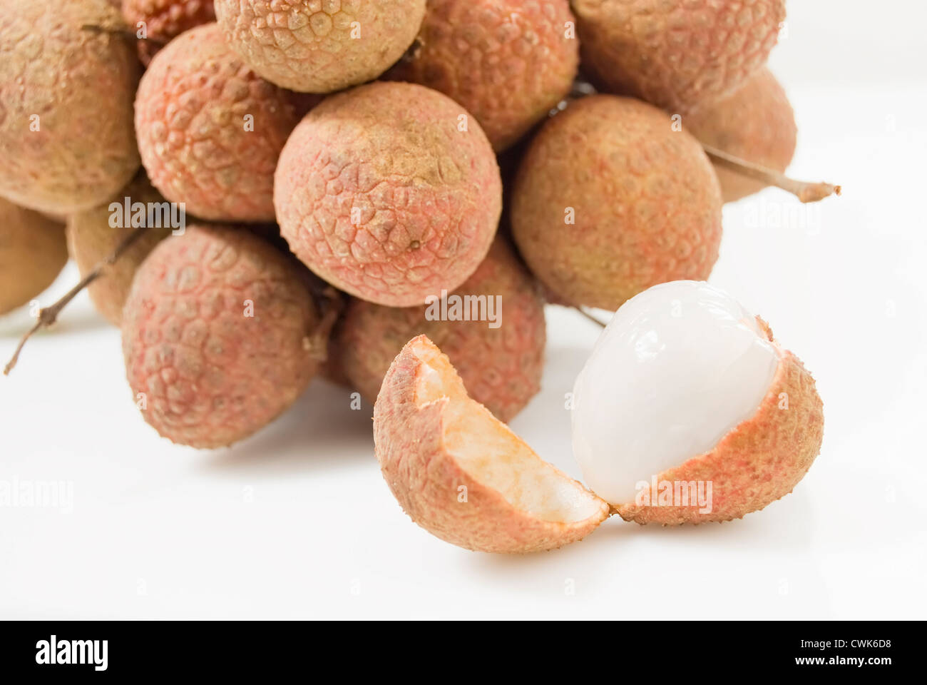 Bunch of Lychees on white background Stock Photo - Alamy