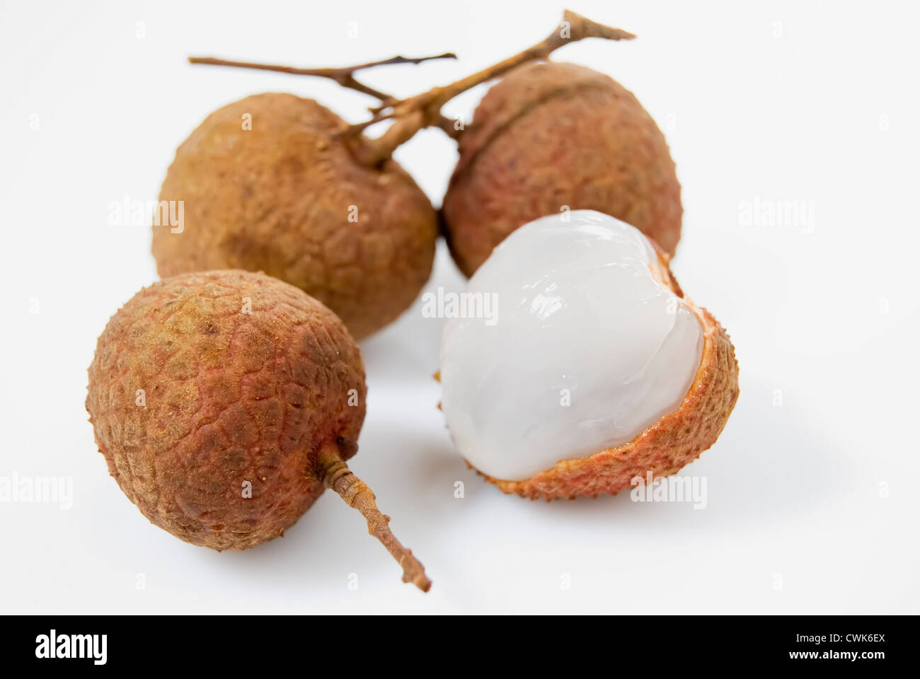 Four pieces of lychees on white background Stock Photo - Alamy