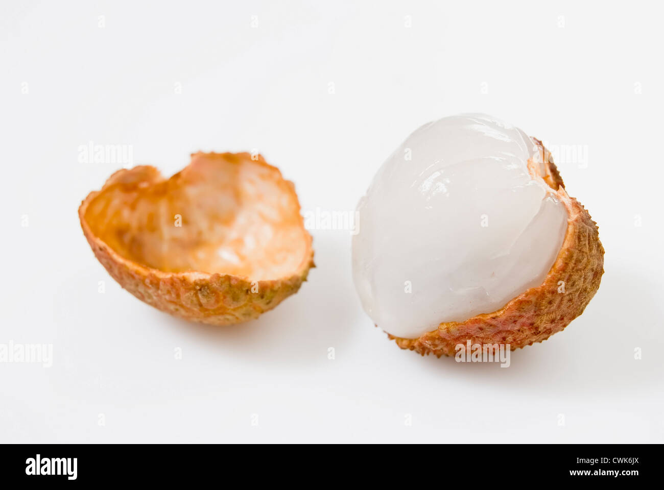 Macro of opened lychee on white background Stock Photo - Alamy