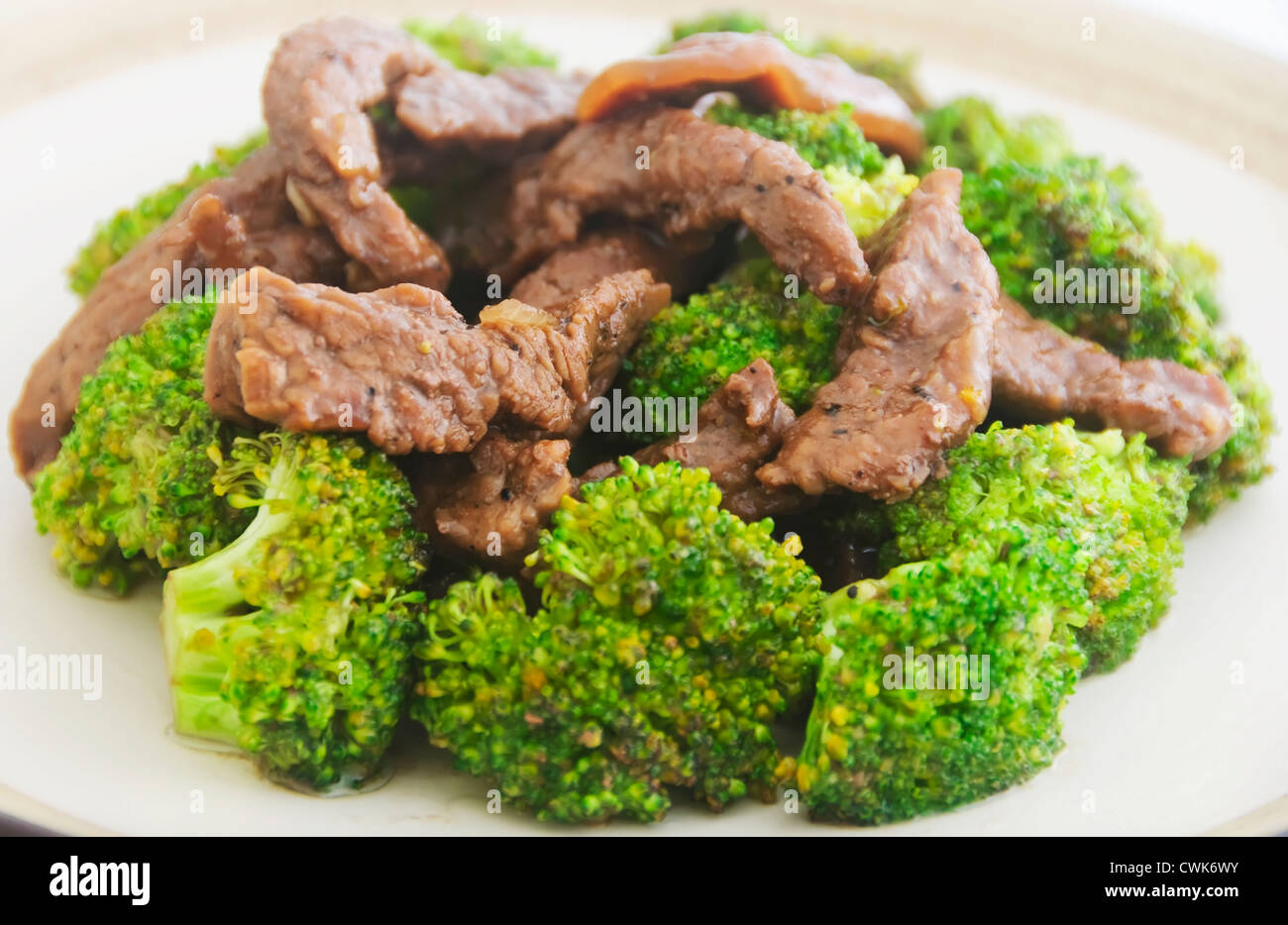 Close-up of beef broccoli on plate; shot against white background Stock ...