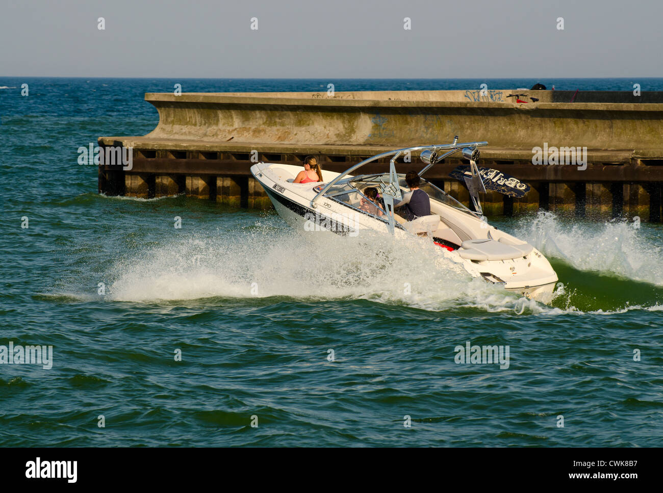 Motor boat entering open water Stock Photo - Alamy