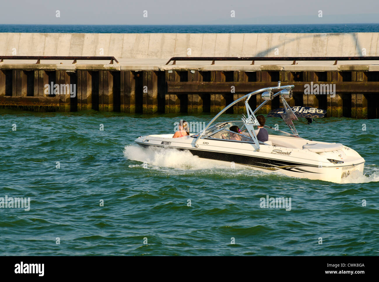 Motor boat passing through a channel Stock Photo - Alamy
