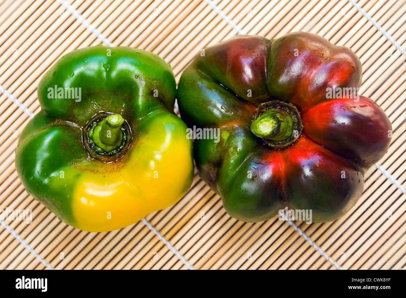 Big bell peppers on wooden mat Stock Photo - Alamy