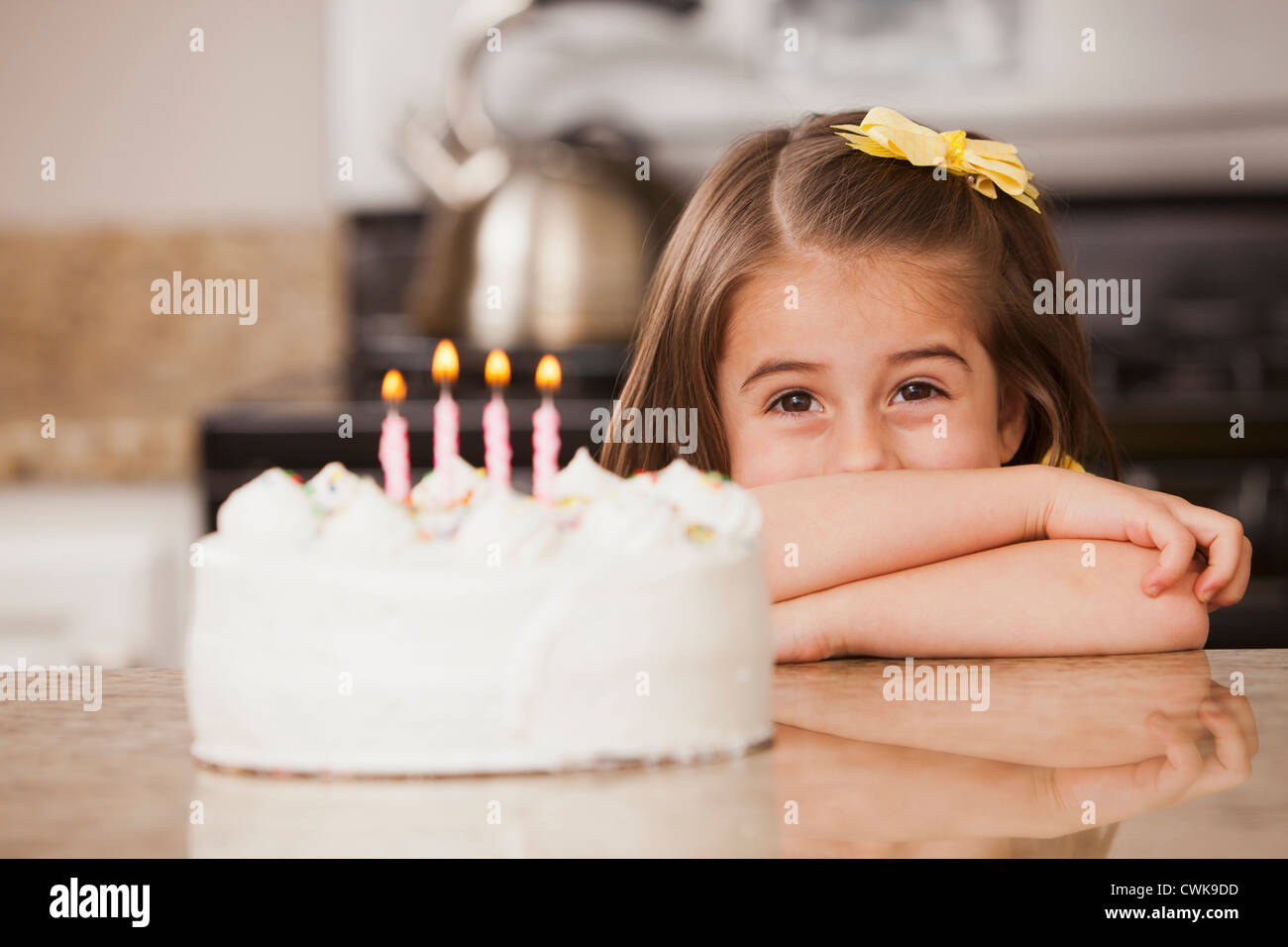 Caucasian girl looking at birthday cake Stock Photo - Alamy