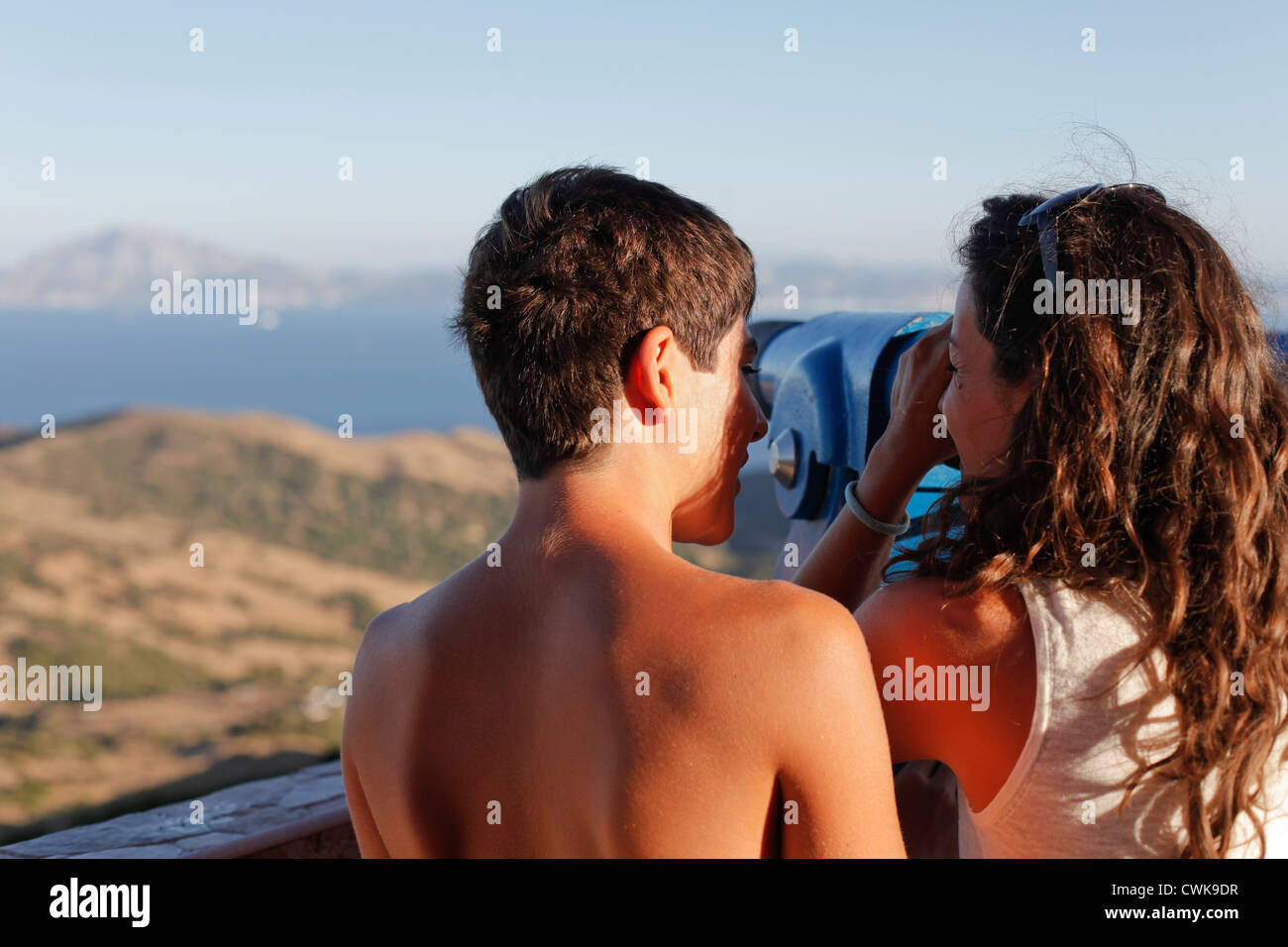 Two kids using a telescope at the Strait of Gibraltar Stock Photo - Alamy