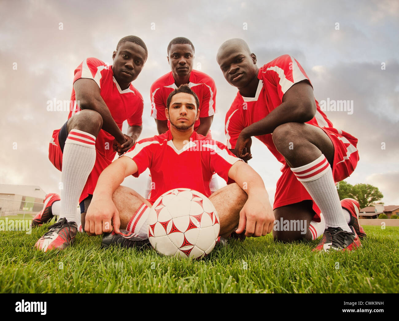 Soccer players posing with ball Stock Photo - Alamy