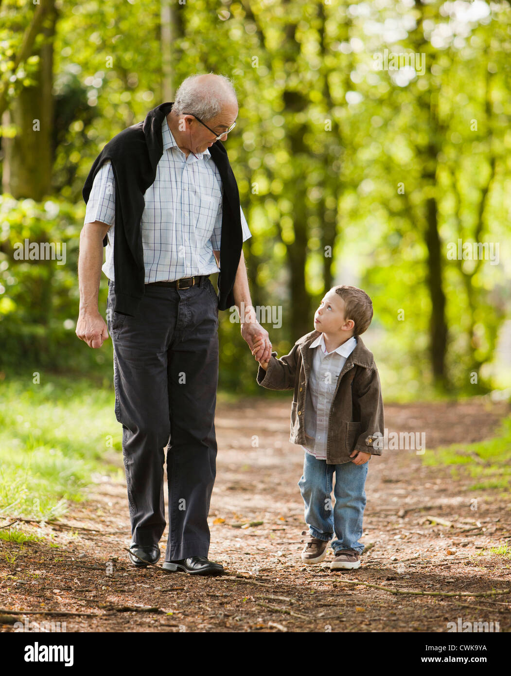 Caucasian grandfather and grandson walking in woods Stock Photo - Alamy