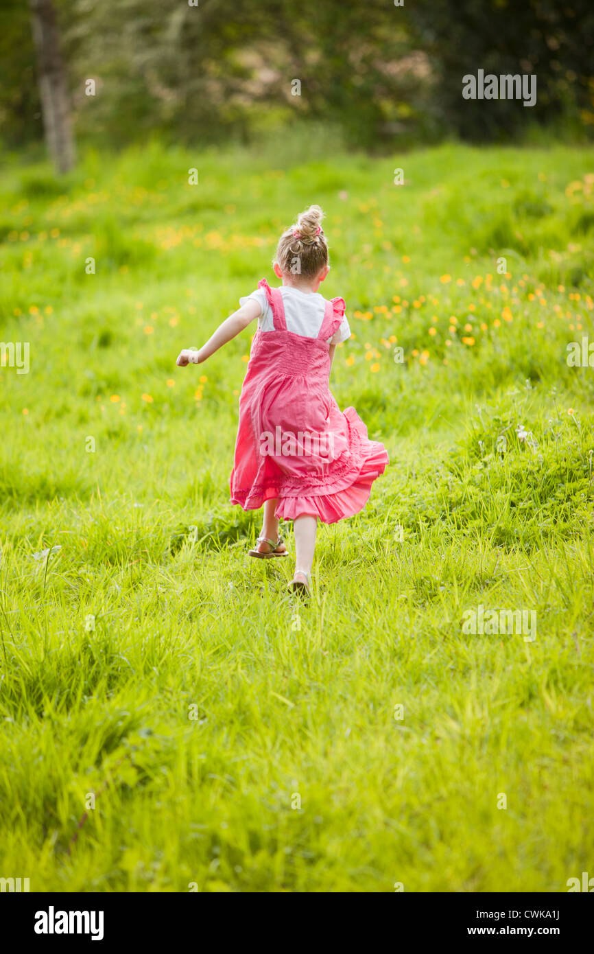 Caucasian girl running in field Stock Photo - Alamy