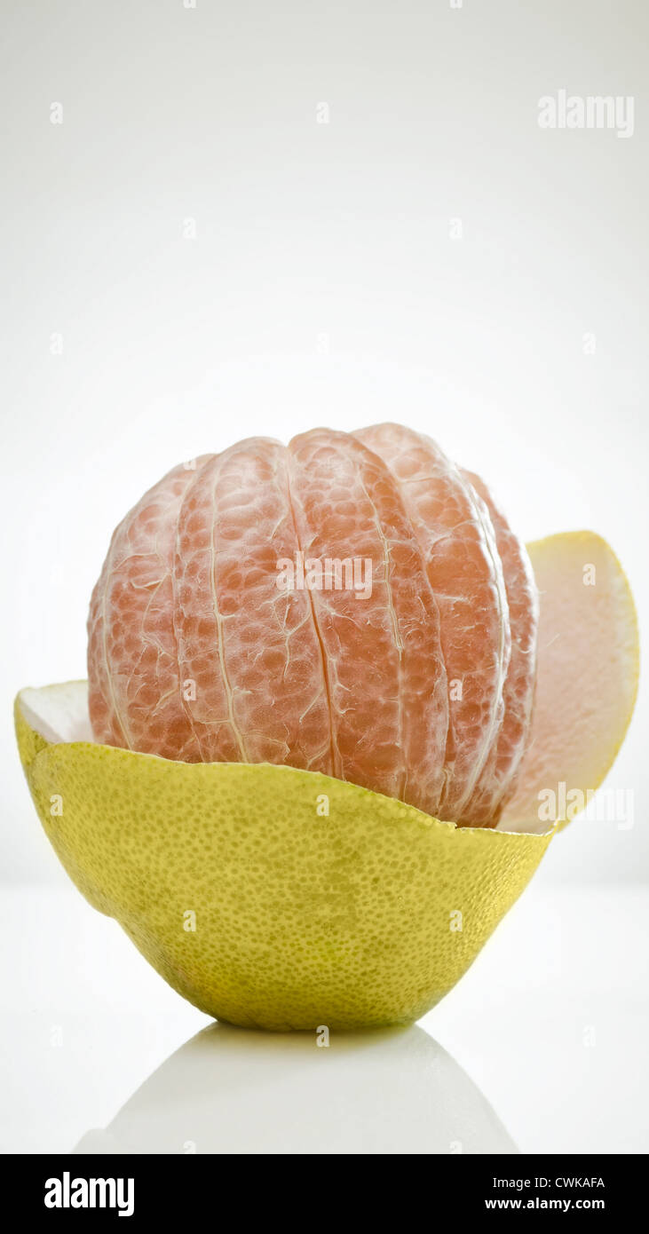 Ripe pomelo with its rind against white background Stock Photo - Alamy