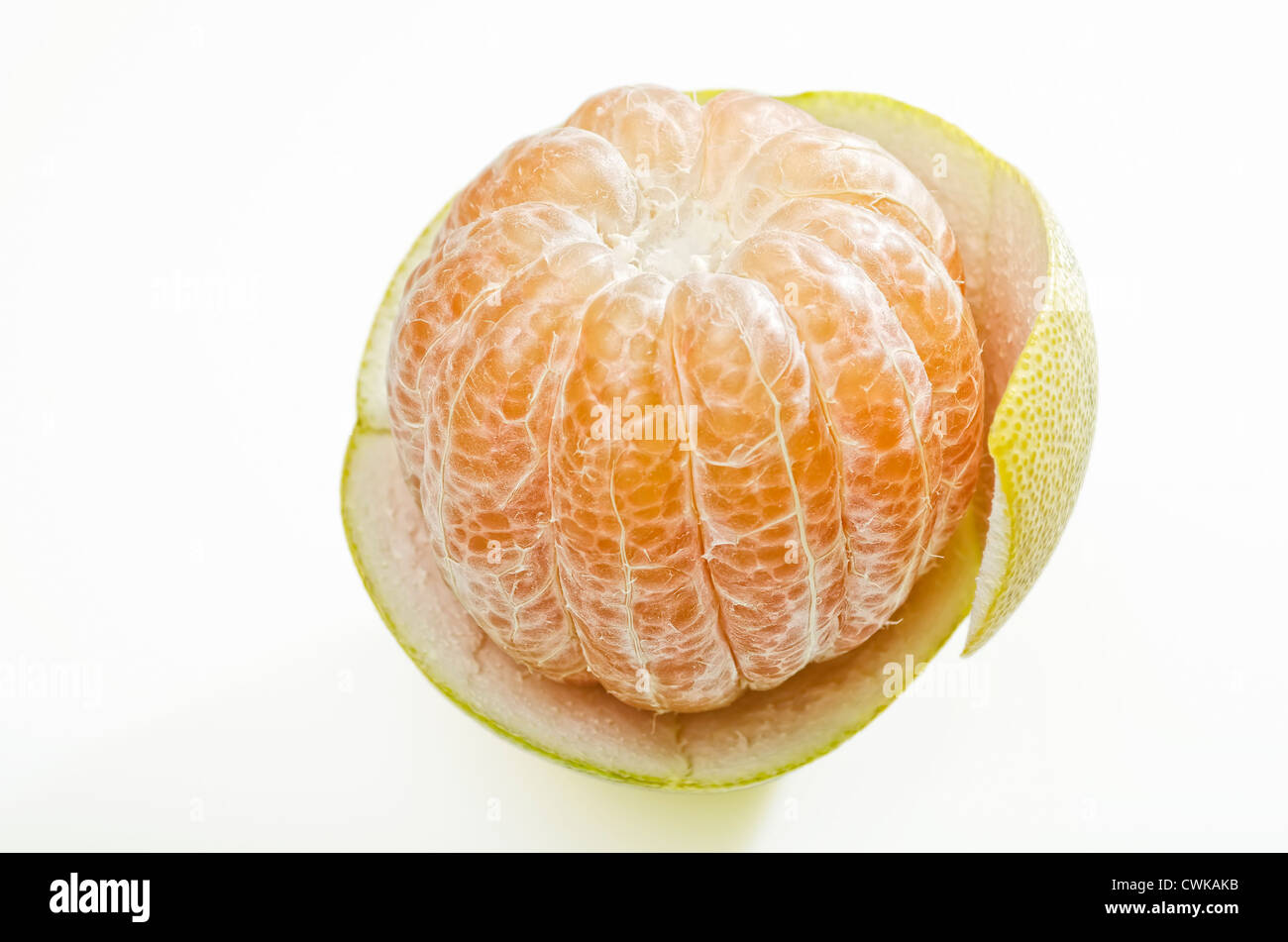 Ripe pomelo with its rind shot on white background Stock Photo - Alamy