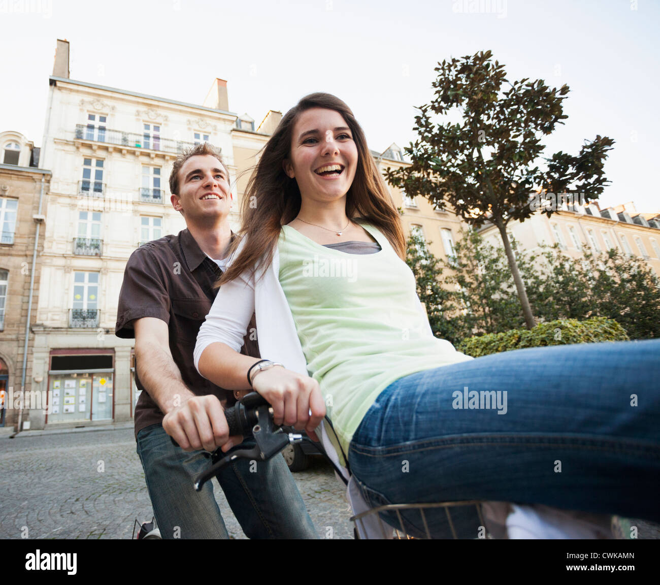 Caucasian couple riding bicycle together Stock Photo - Alamy