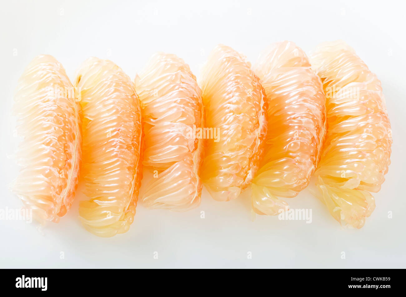 Pulp of ripe pomelo on white background Stock Photo - Alamy