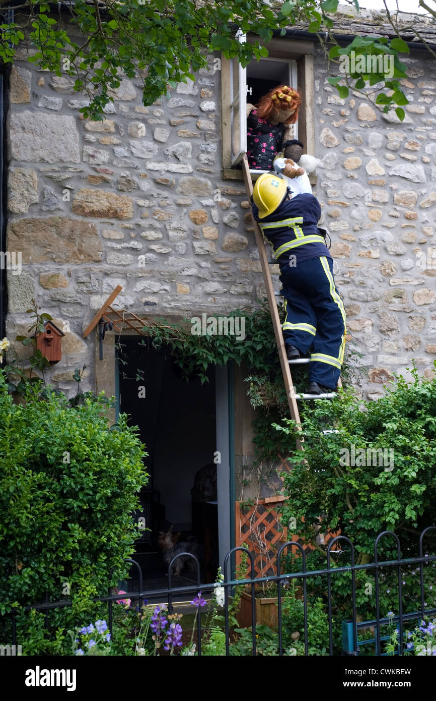 scarecrow at kettlewell festival depicting fireman rescuing mother and ...