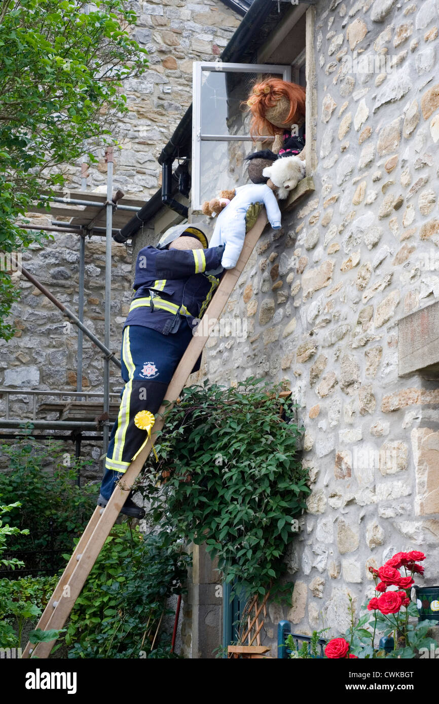 scarecrows at kettlewell festival depicting a fireman rescuing a mother ...