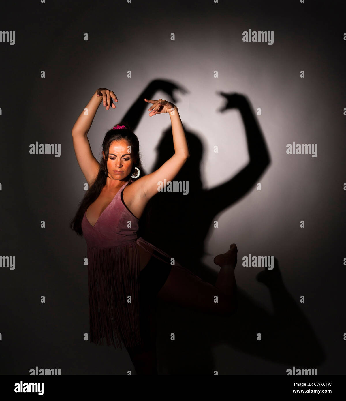 Elegant Hispanic dancer hand her spotlit silhouette Stock Photo - Alamy