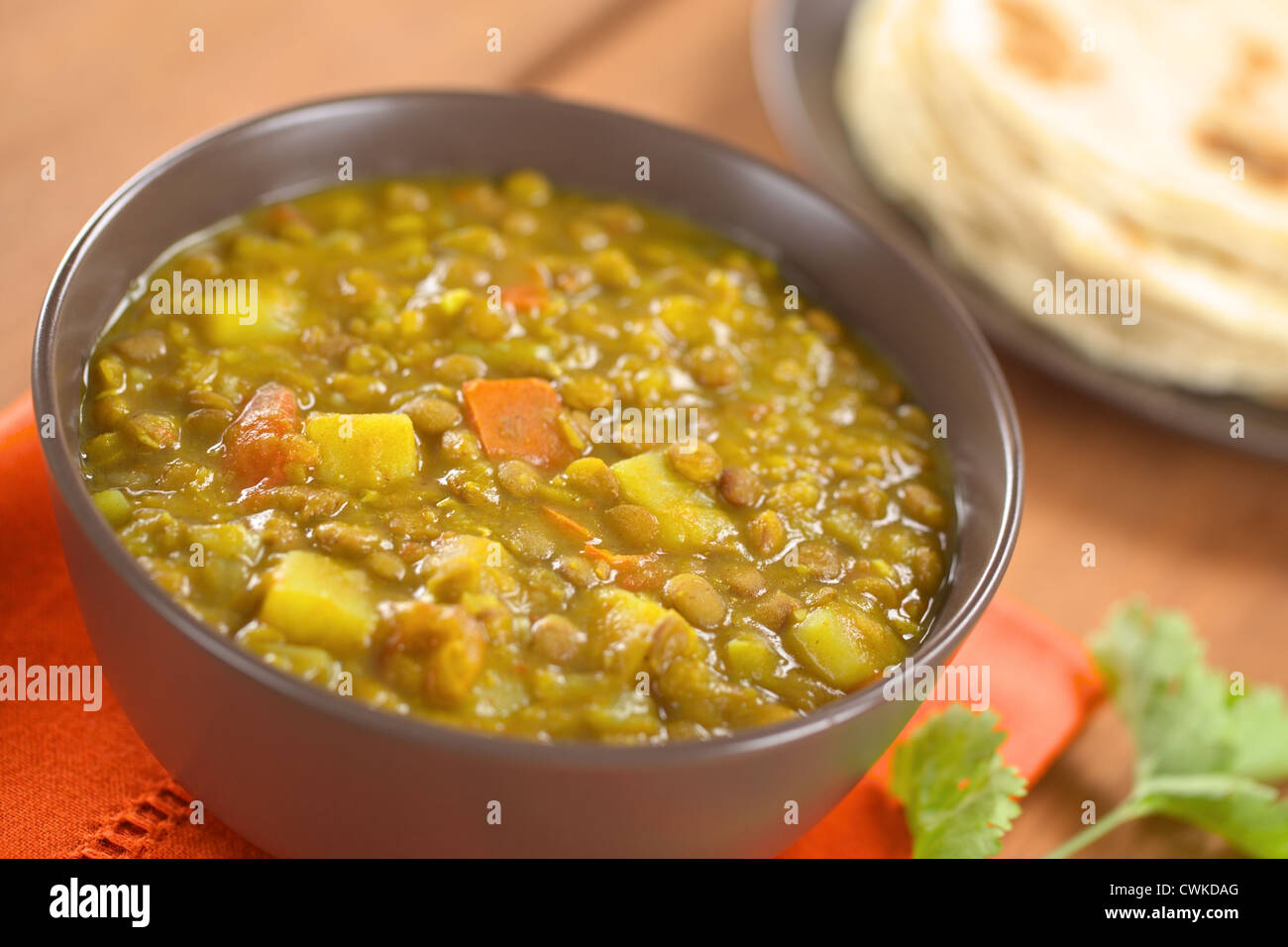 Bowl of spicy Indian dal (lentil) curry prepared with carrot and potato ...