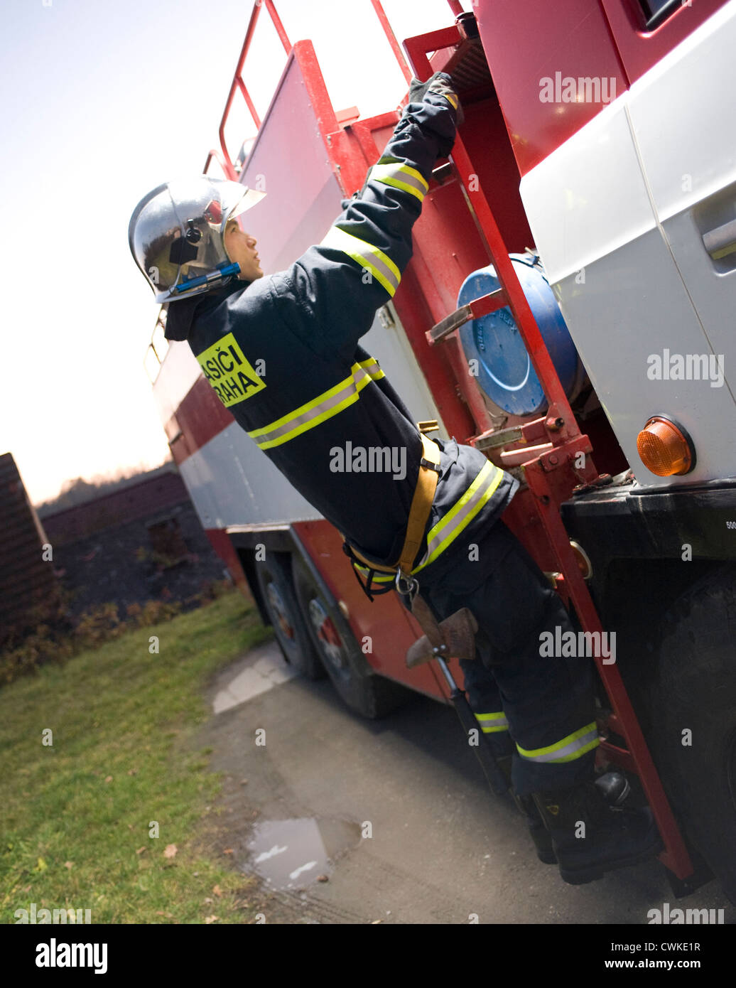 Fireman uniform helmet climbing ladder hi-res stock photography and ...