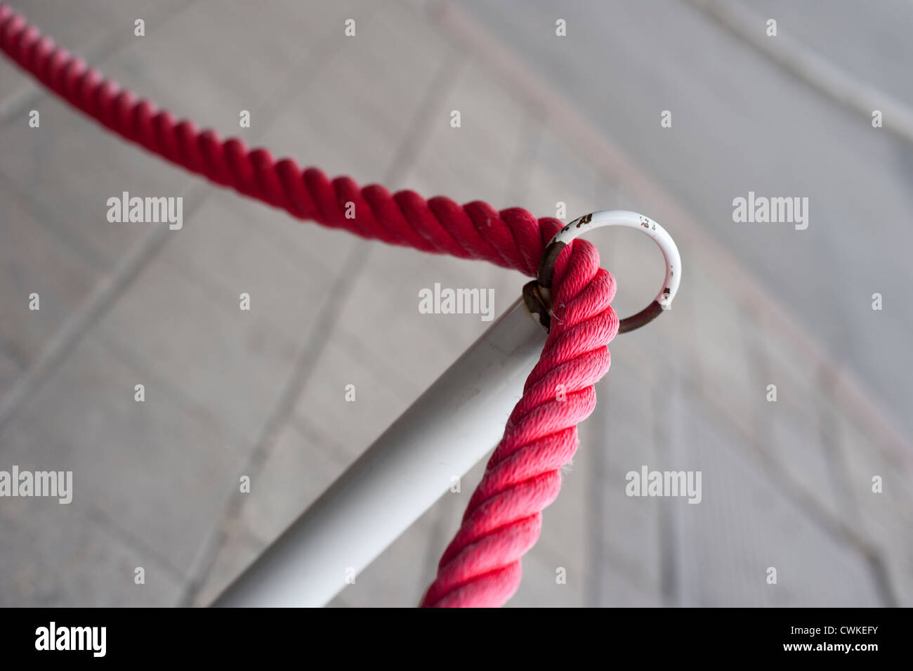 Thick red rope on a picket to ward off uninvited visitors Stock Photo ...