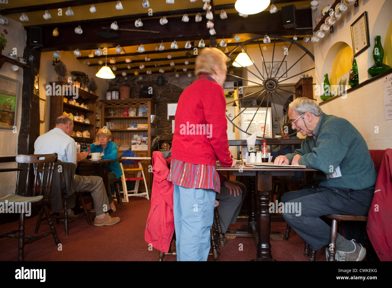 Interior of small cafe with standing and seated Patrons, Kirkby Stephen ...