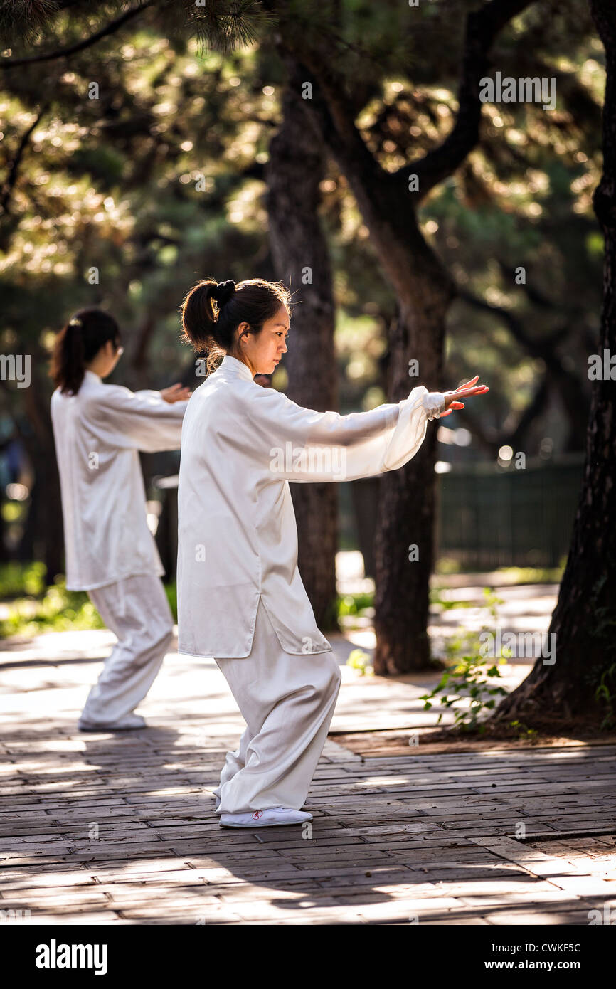 Chinese people practices tai chi martial arts exercise early morning at ...