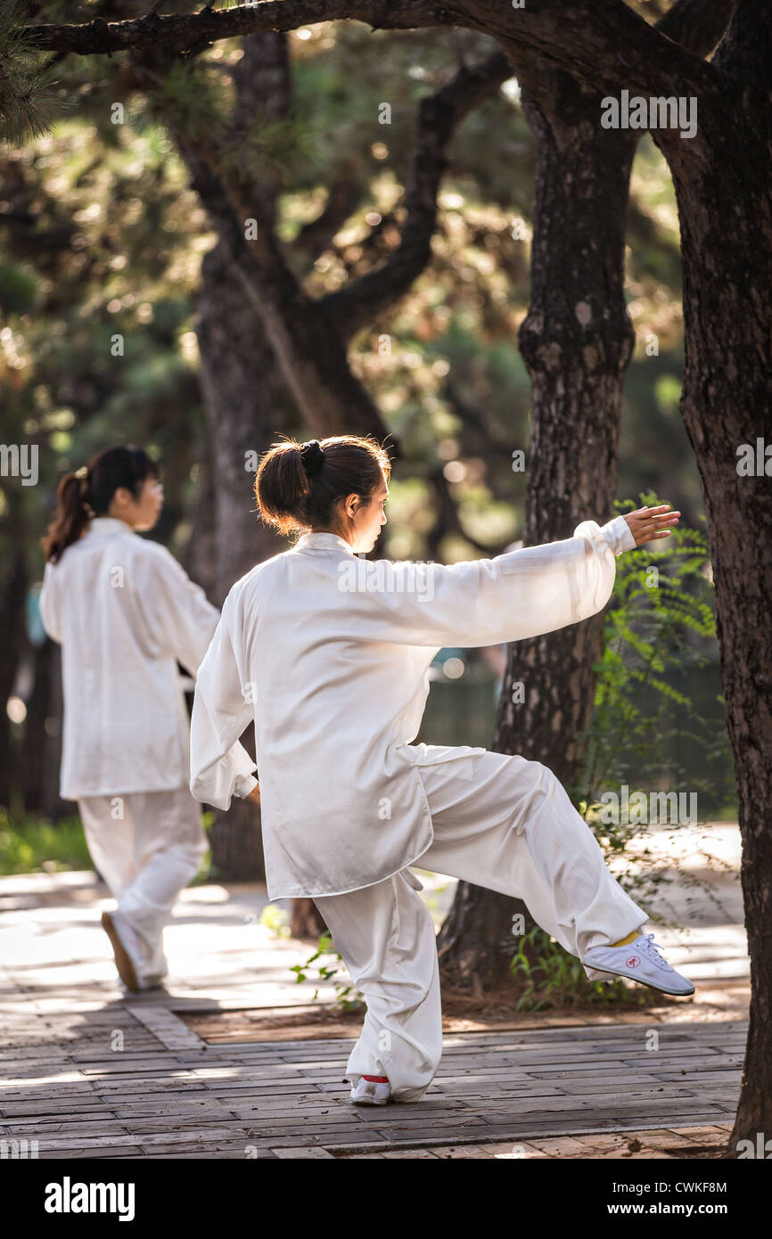 Chinese people practices tai chi martial arts exercise early morning at ...