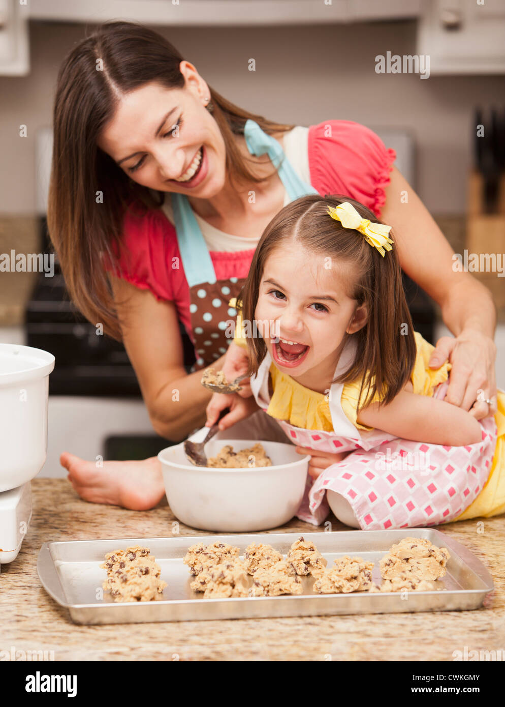 Mother daughter mixing dough together hi-res stock photography and ...