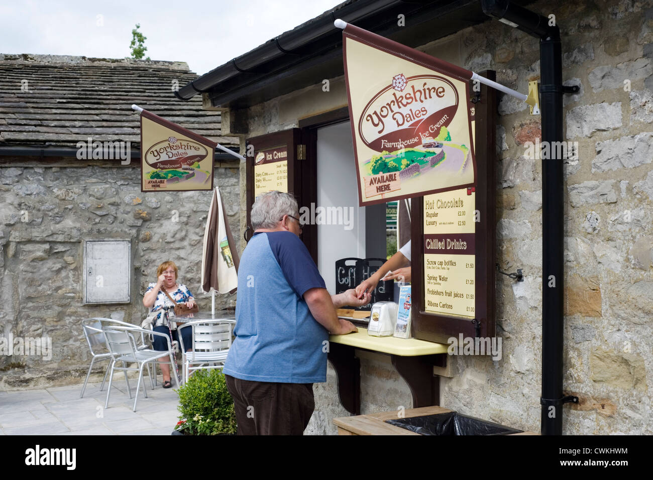 man buying refreshments at small shop for his companion during the ...