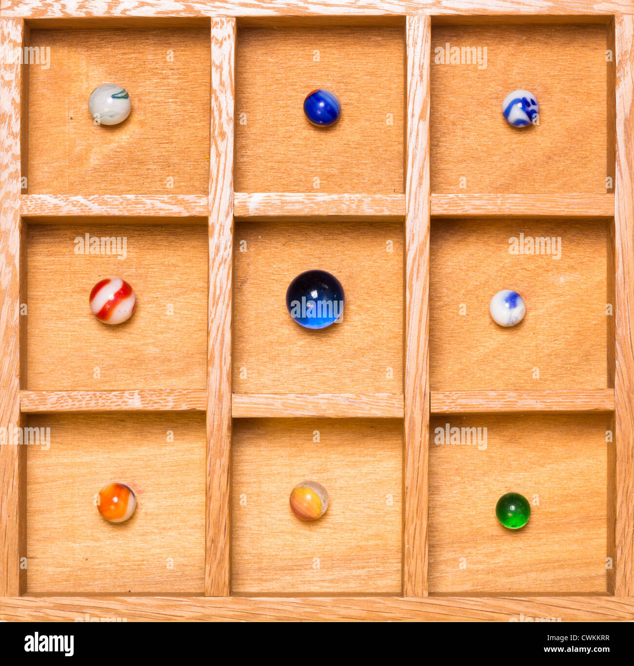 Wooden shadow box with collection of antique marbles Stock Photo - Alamy