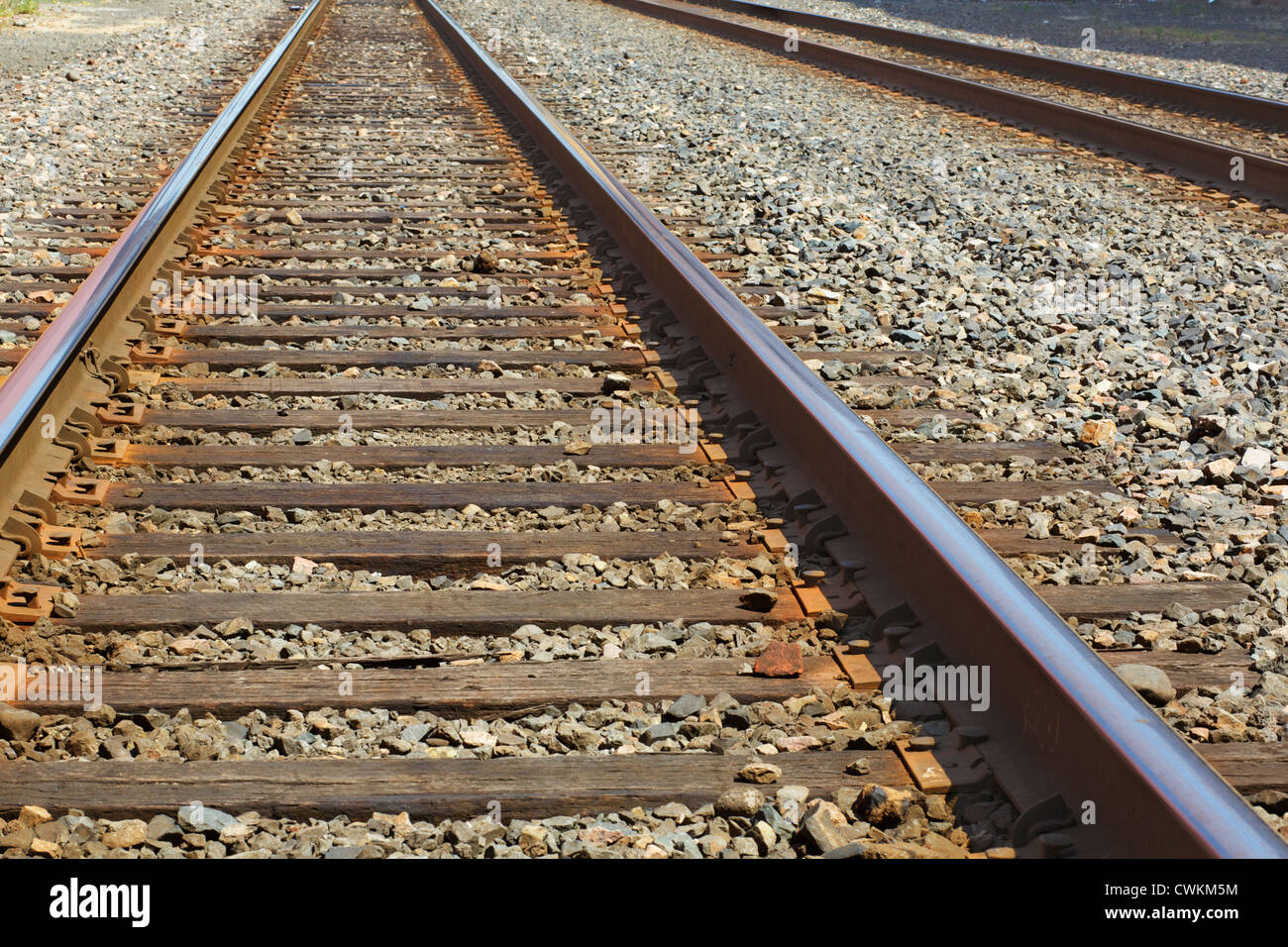Two sets of Diminishing straight train tracks on a gravel bed Stock ...