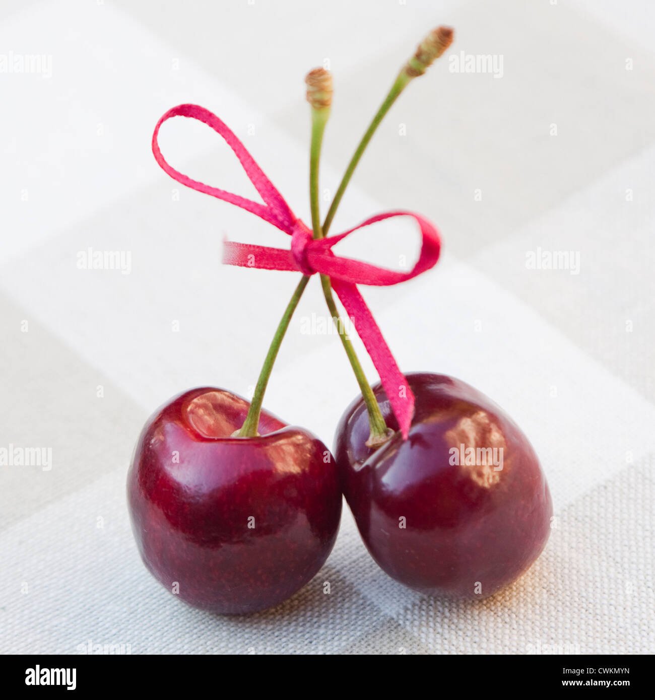 two cherries together with a loop Stock Photo - Alamy